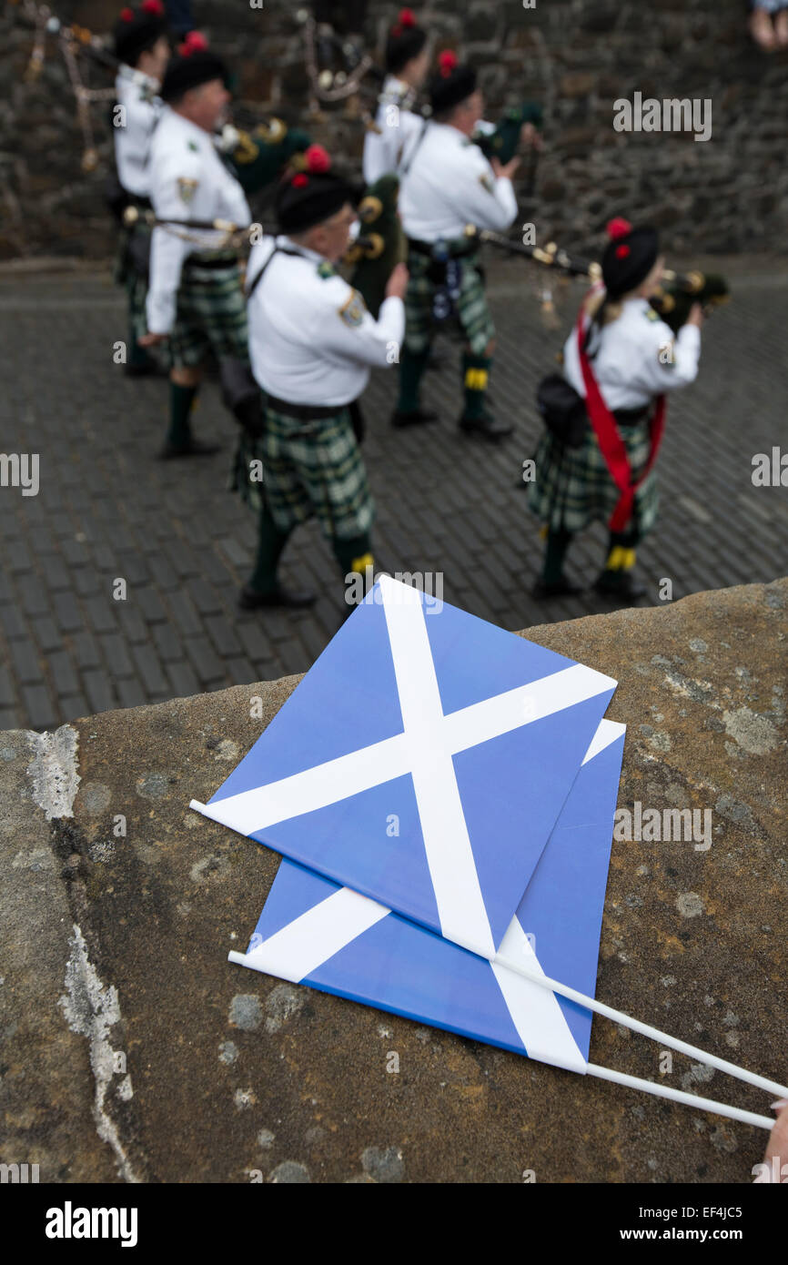 A Scottish saltire lying on a wall as a traditional Scottish pipe band ...