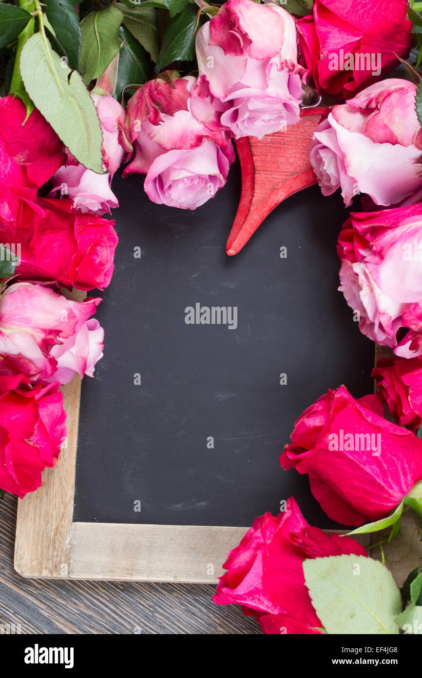 red and pink roses frame on table Stock Photo - Alamy