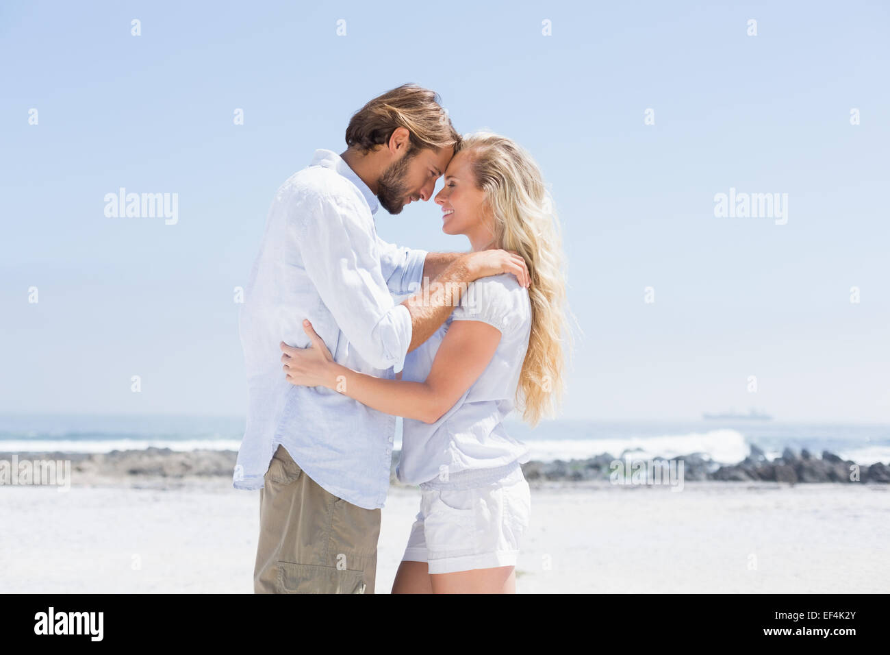 Cute couple hugging on the beach Stock Photo - Alamy