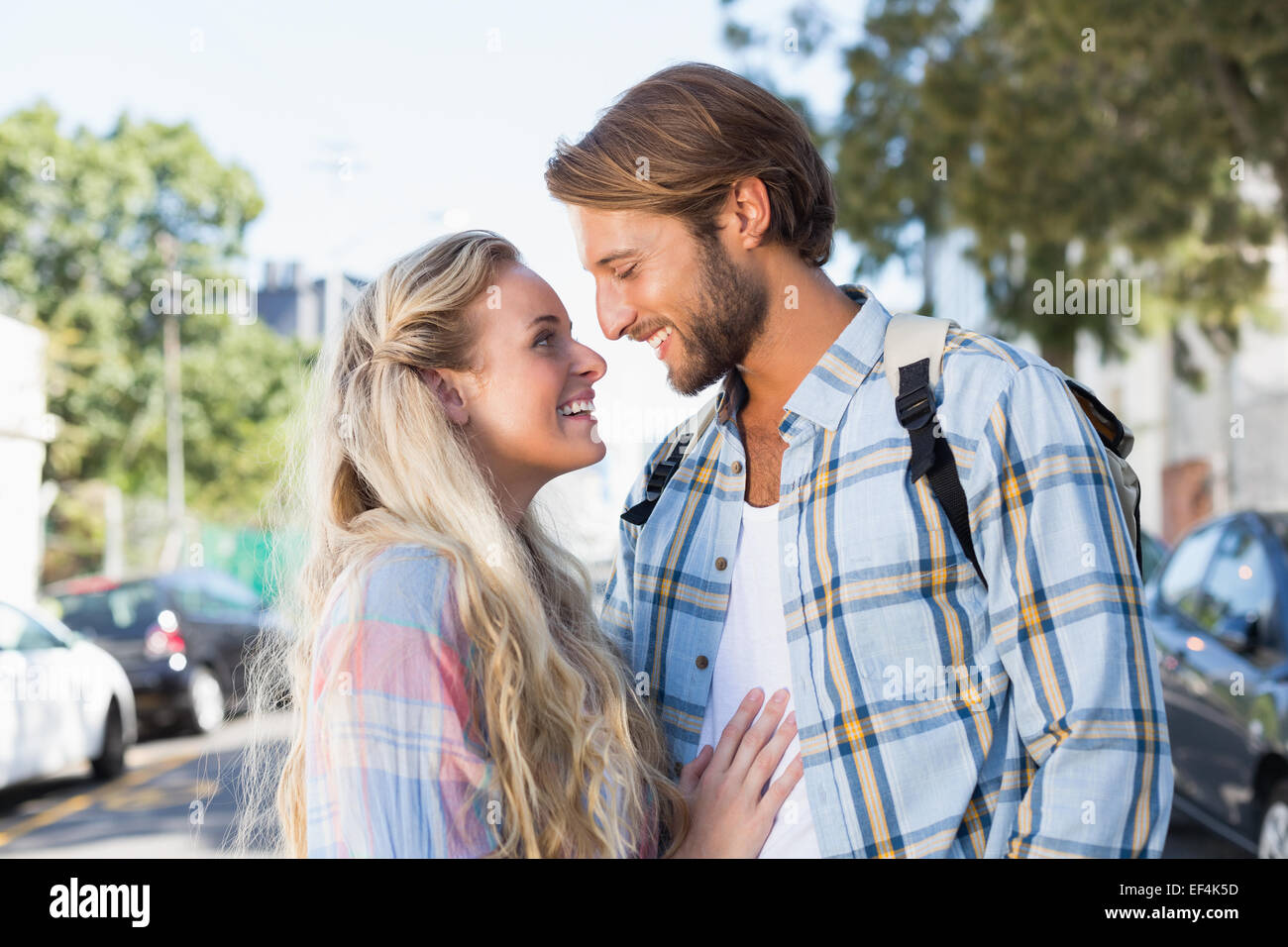 Attractive couple standing and hugging Stock Photo - Alamy