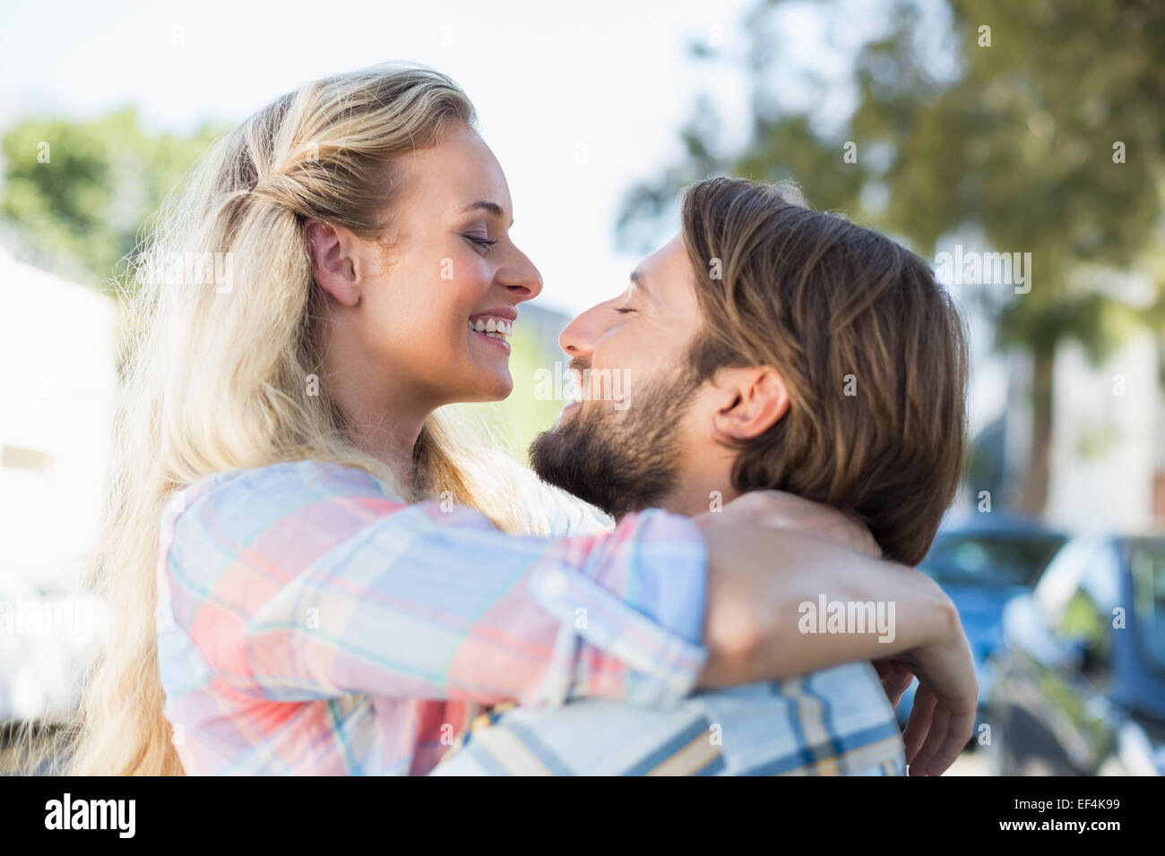 Attractive couple standing and hugging Stock Photo - Alamy