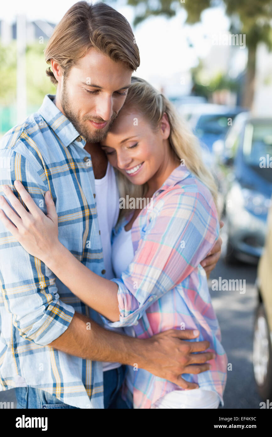 Attractive couple standing and hugging Stock Photo - Alamy