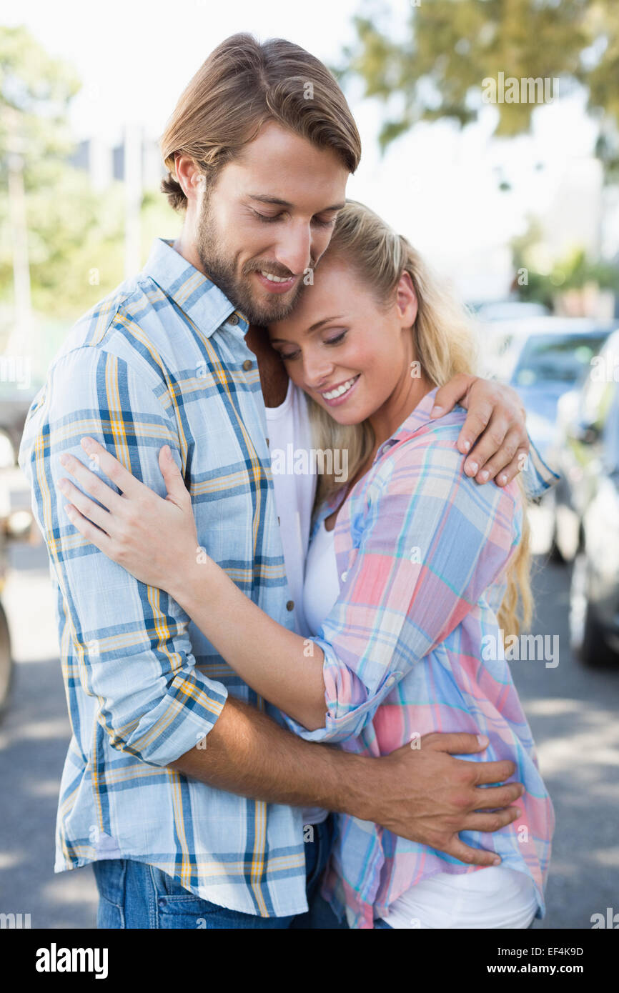 Attractive couple standing and hugging Stock Photo - Alamy