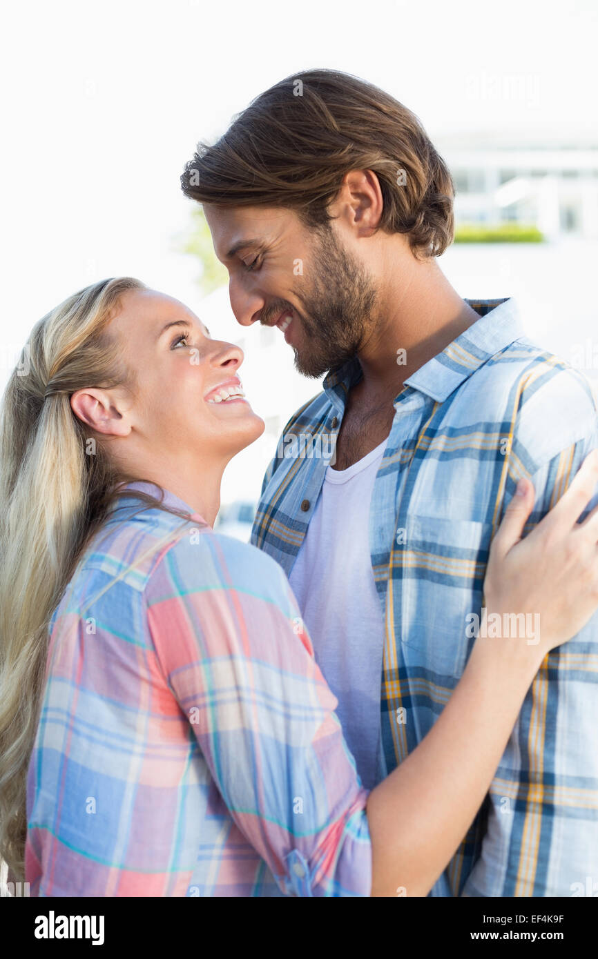 Attractive couple standing and hugging Stock Photo - Alamy