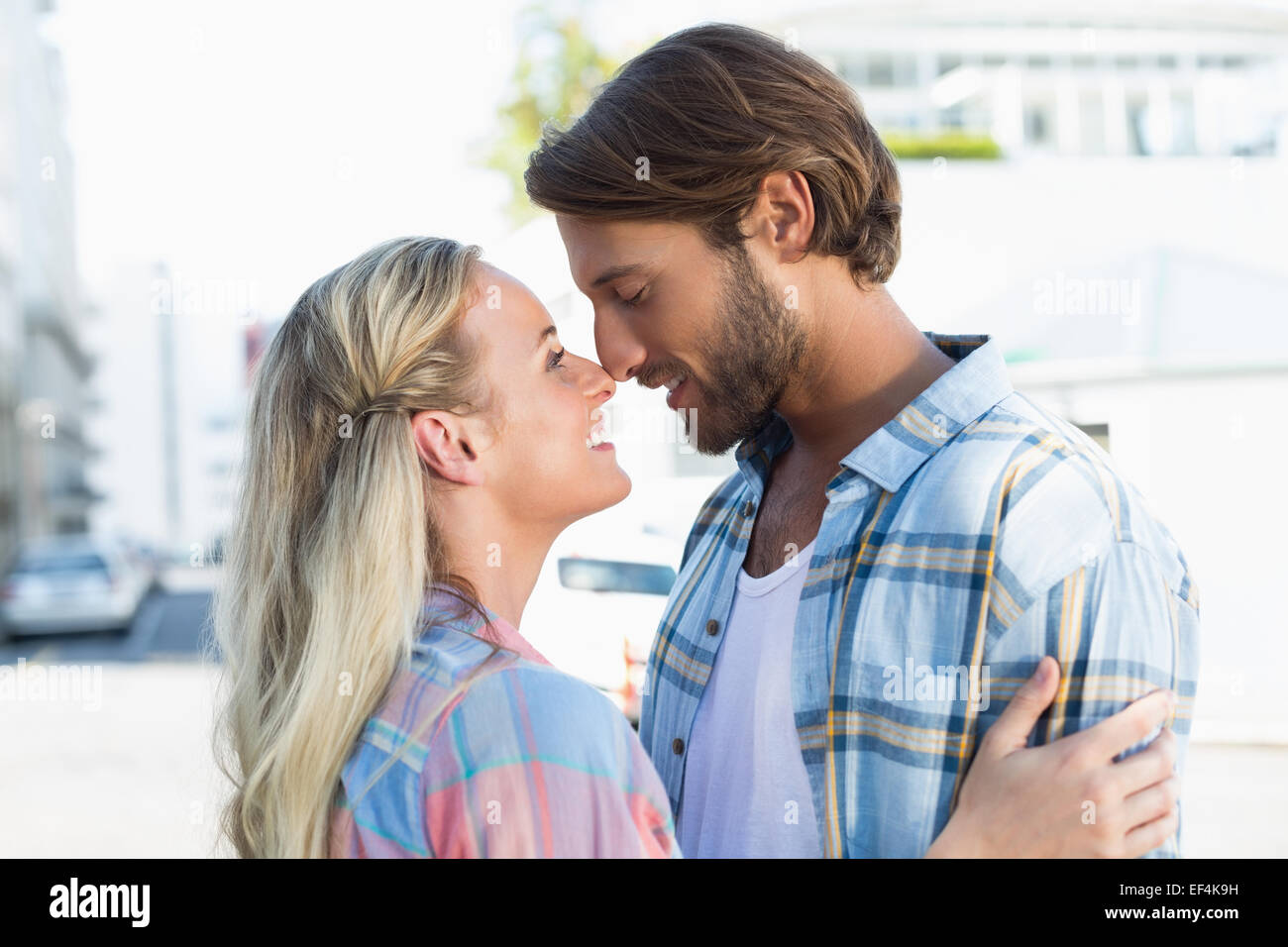 Attractive couple standing and hugging Stock Photo - Alamy