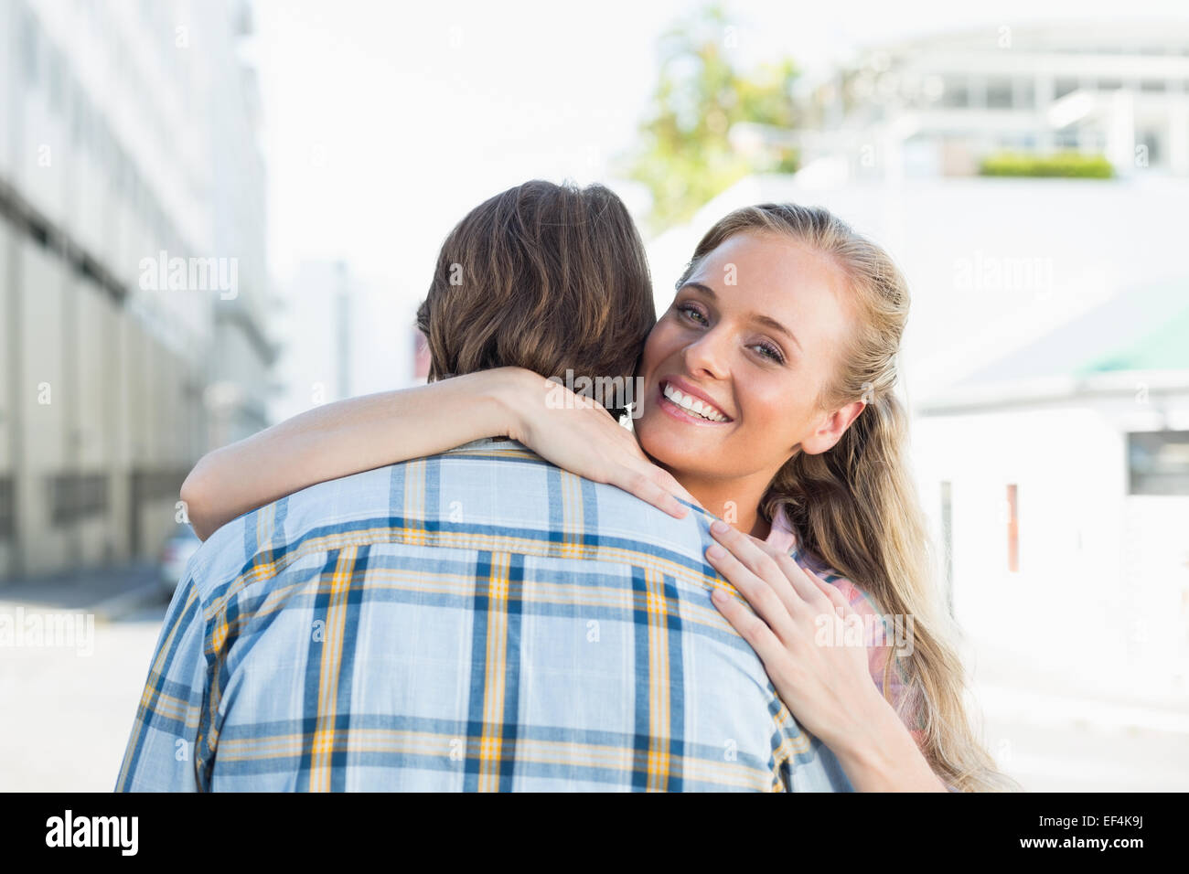 Attractive couple standing and hugging Stock Photo - Alamy