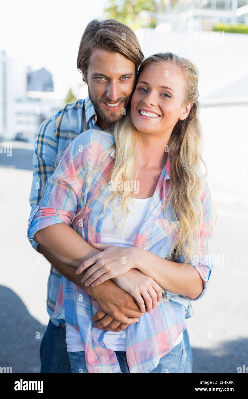 Attractive couple standing and hugging Stock Photo - Alamy