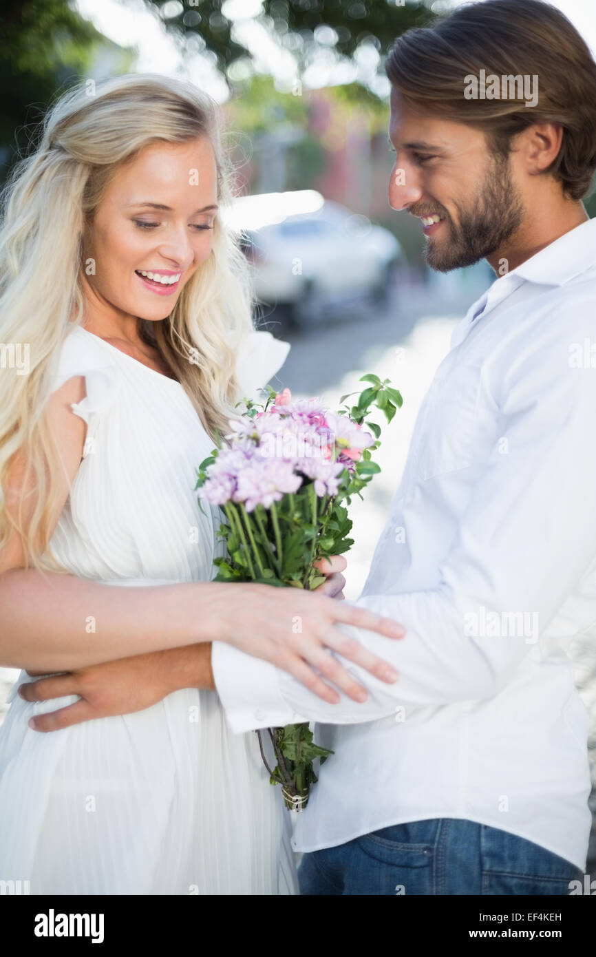 Attractive couple with bunch of flowers Stock Photo - Alamy