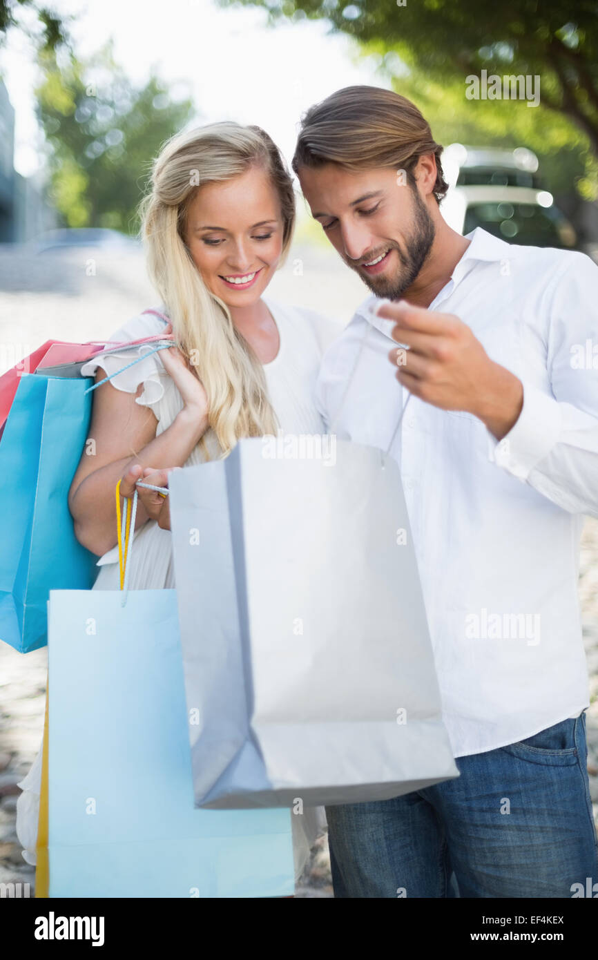 Attractive couple looking at shopping purchases Stock Photo - Alamy