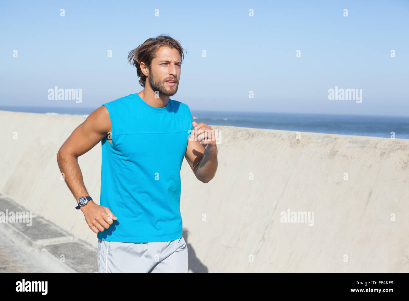Fit man jogging on promenade Stock Photo - Alamy