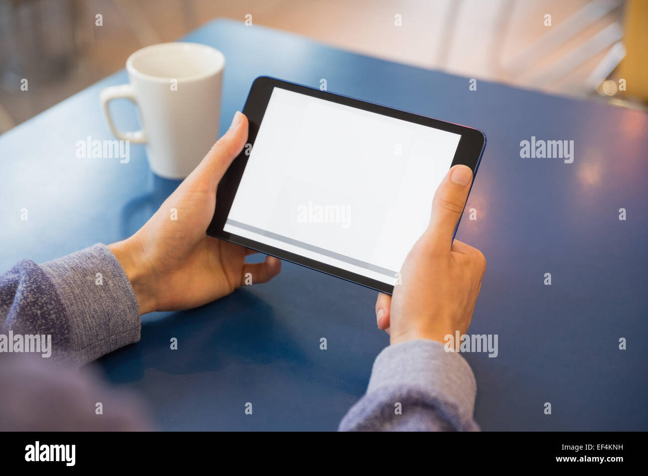 Young student using his tablet in cafe Stock Photo - Alamy