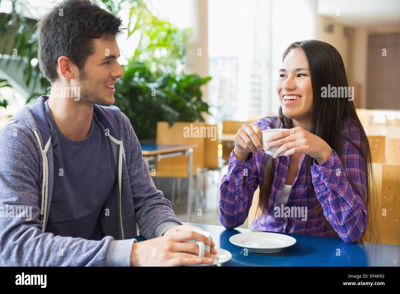 Young students having coffee together Stock Photo - Alamy