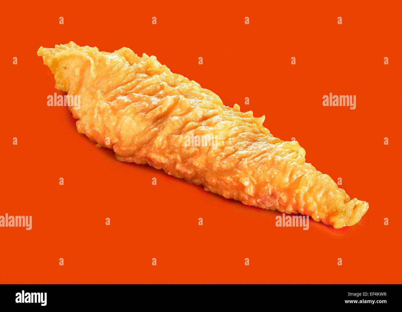 A piece of fried, battered cod on an orange background Stock Photo - Alamy
