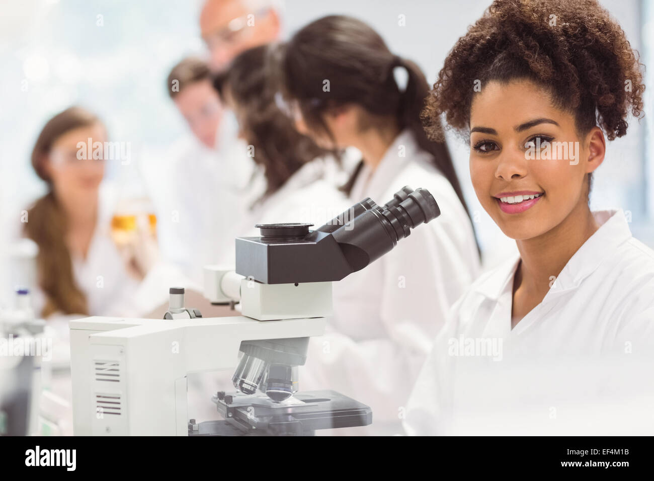 Science student looking through microscope in the lab Stock Photo - Alamy