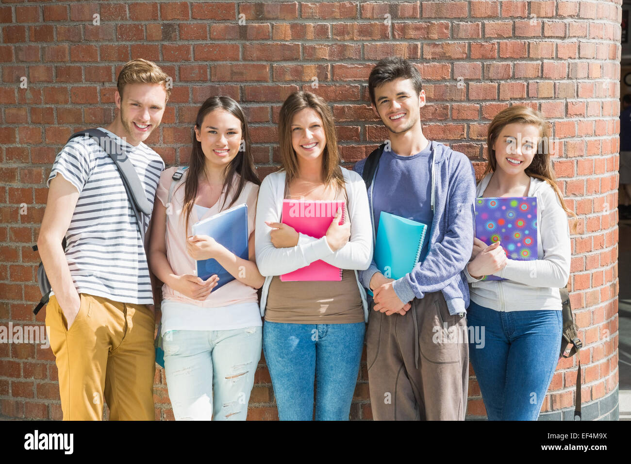 Happy students smiling at camera Stock Photo - Alamy