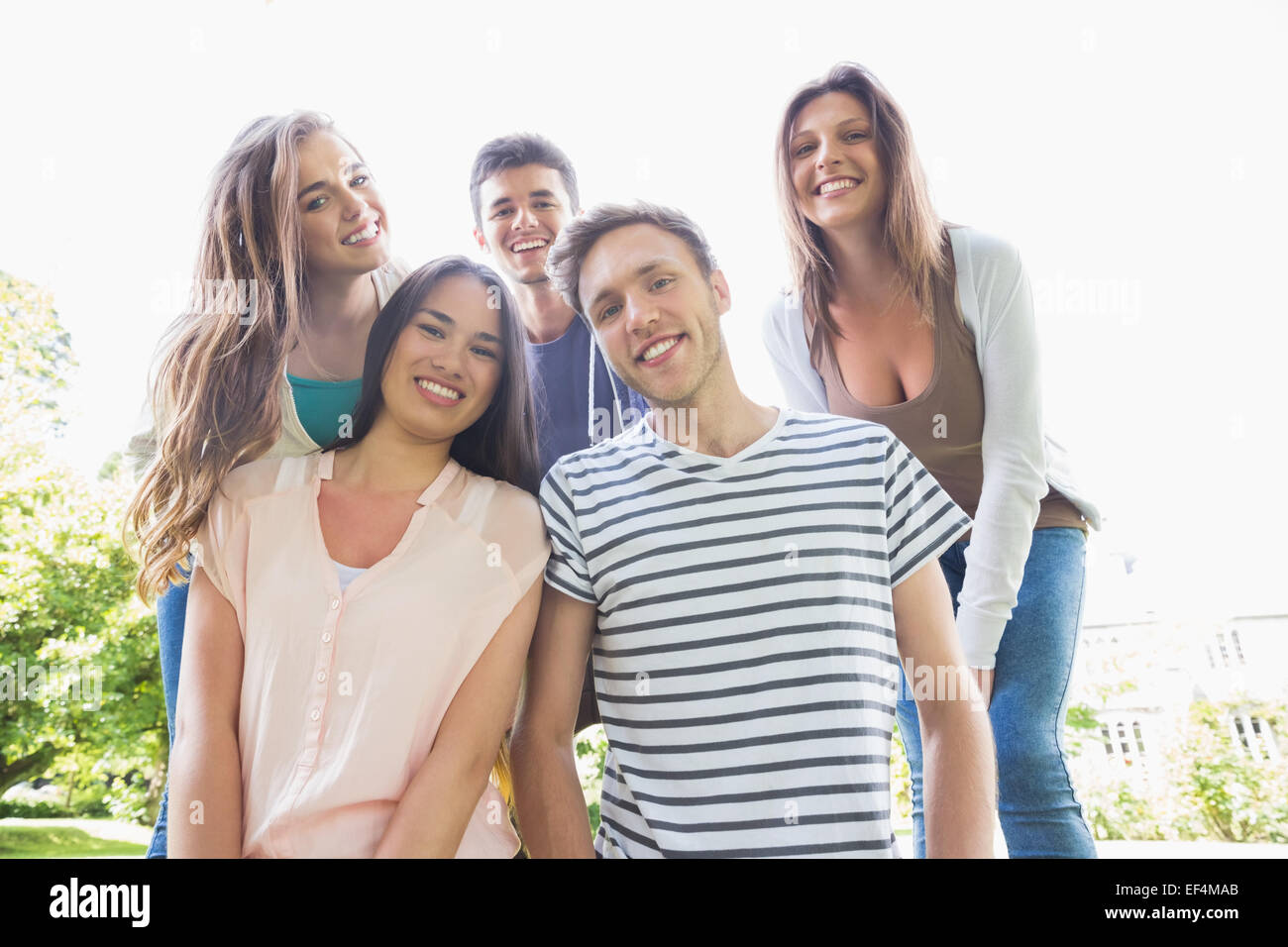 Happy students smiling at camera outside on campus Stock Photo - Alamy
