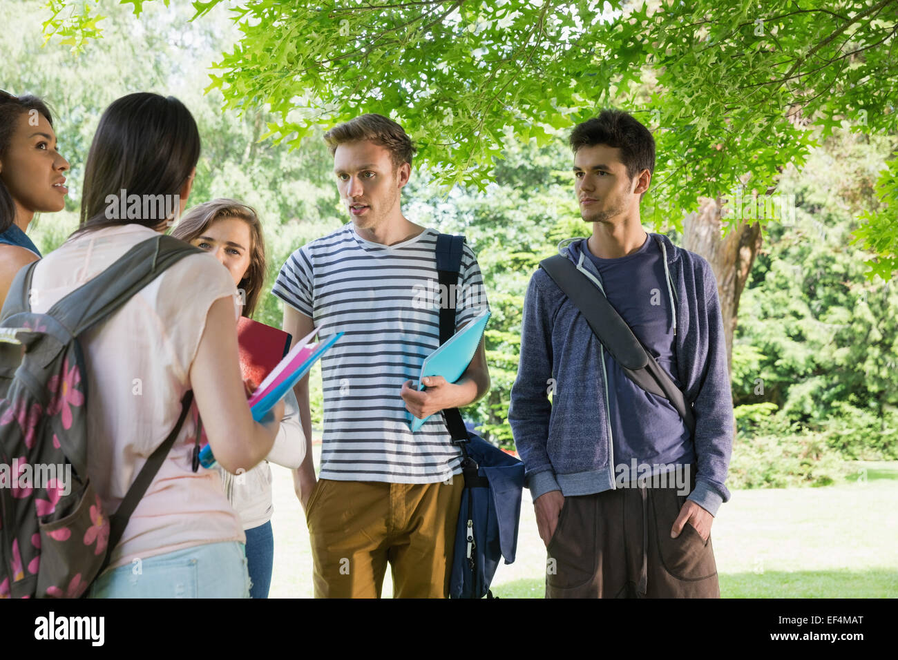 Happy students chatting together outside Stock Photo - Alamy