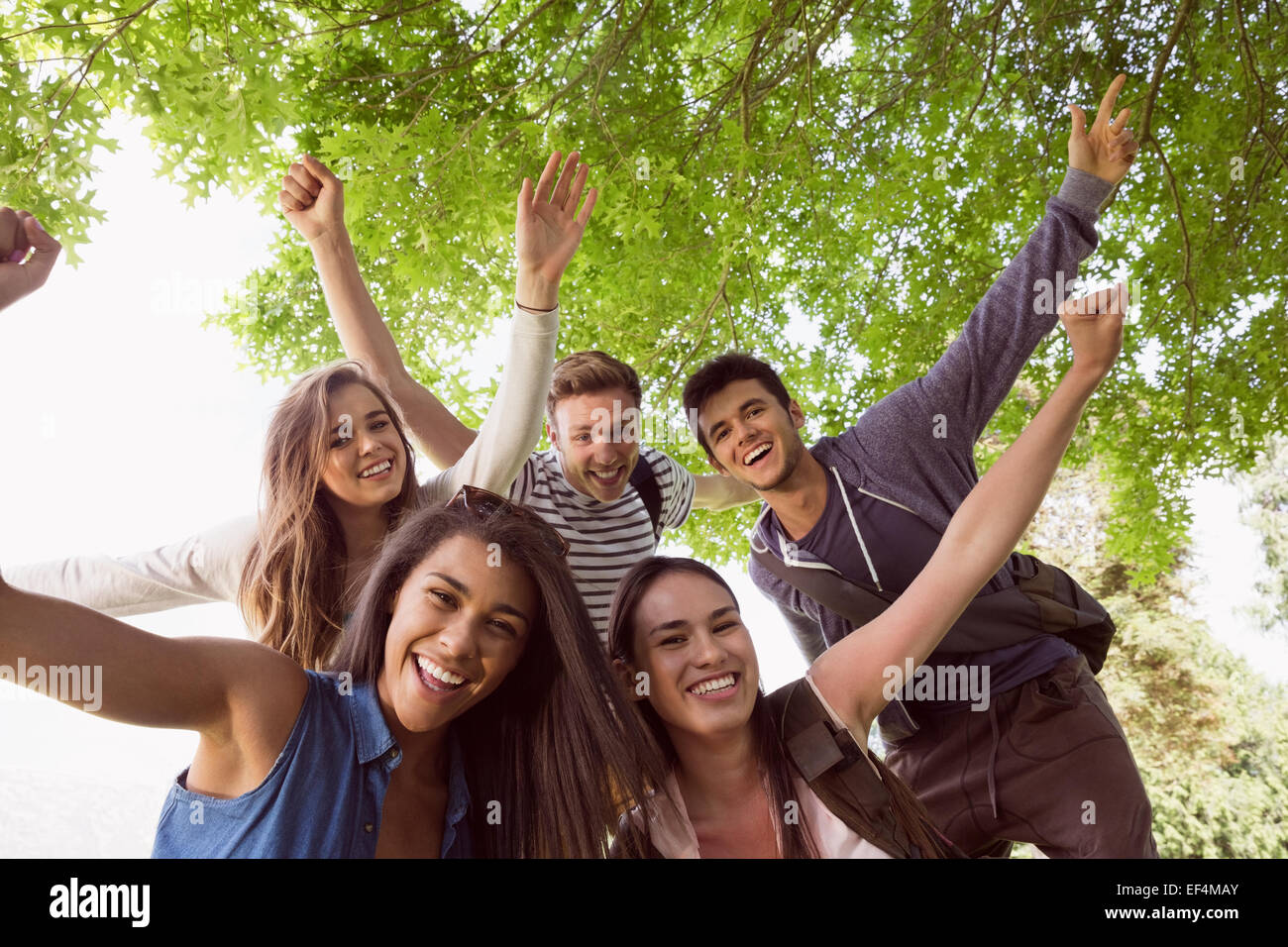 Happy students posing and smiling outside Stock Photo - Alamy