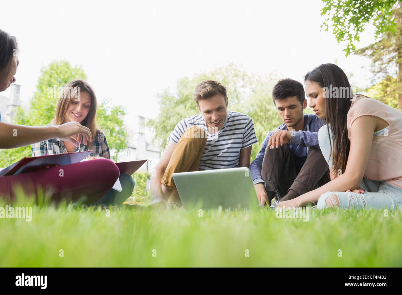 Happy students sitting outside on campus Stock Photo - Alamy