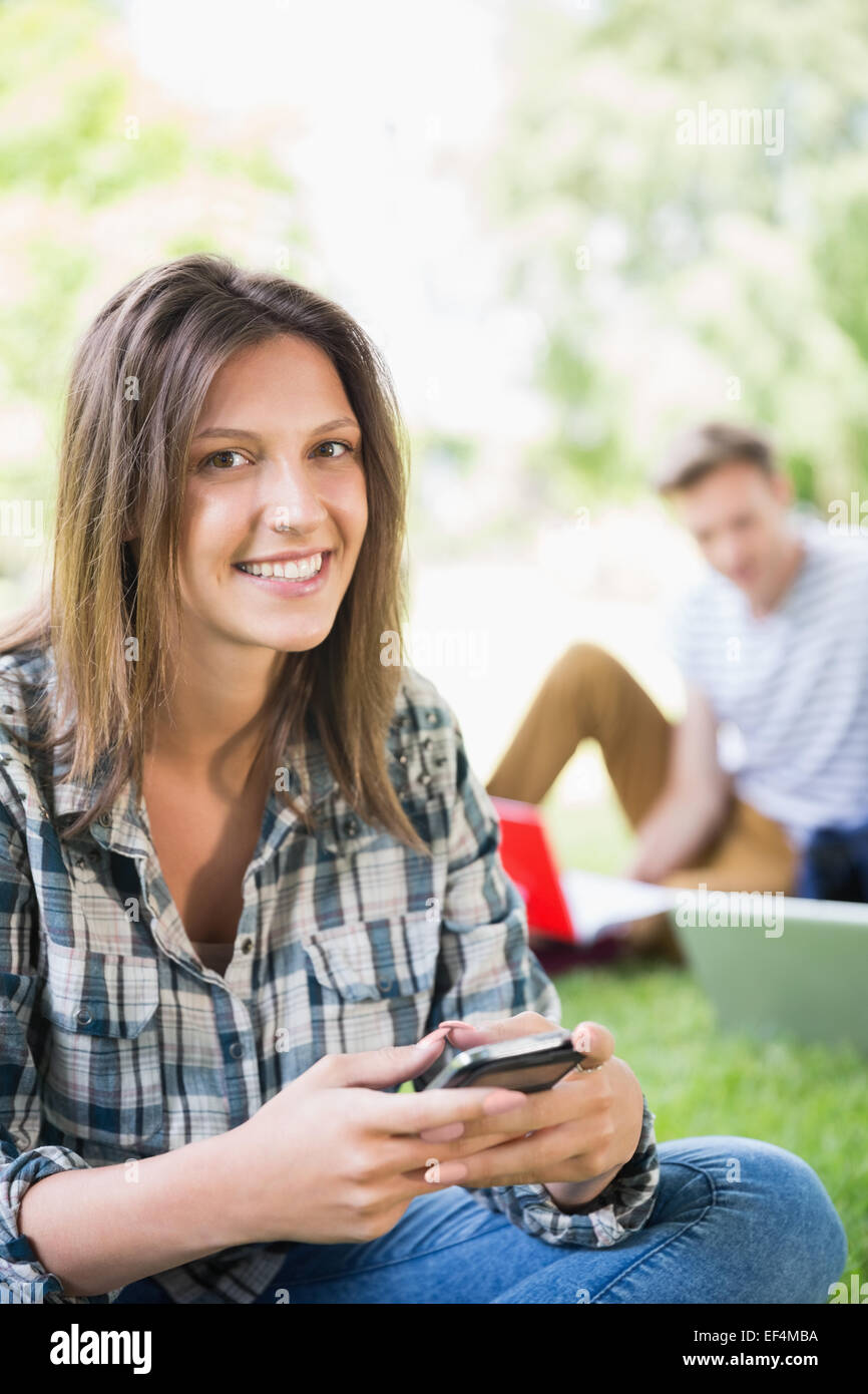 Happy students sitting outside on campus Stock Photo - Alamy
