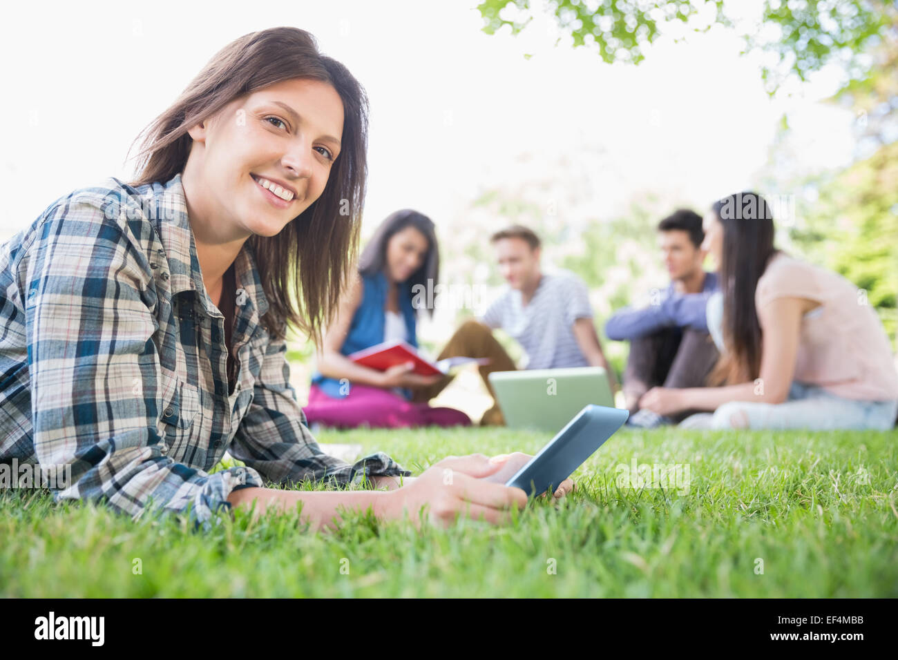Happy students sitting outside on campus Stock Photo - Alamy