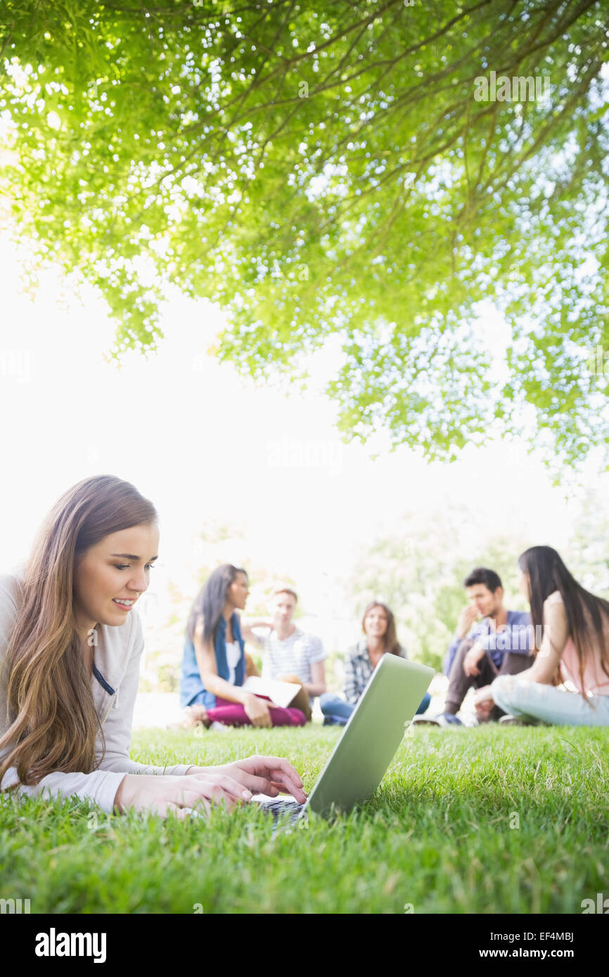 Happy student using her laptop outside Stock Photo - Alamy