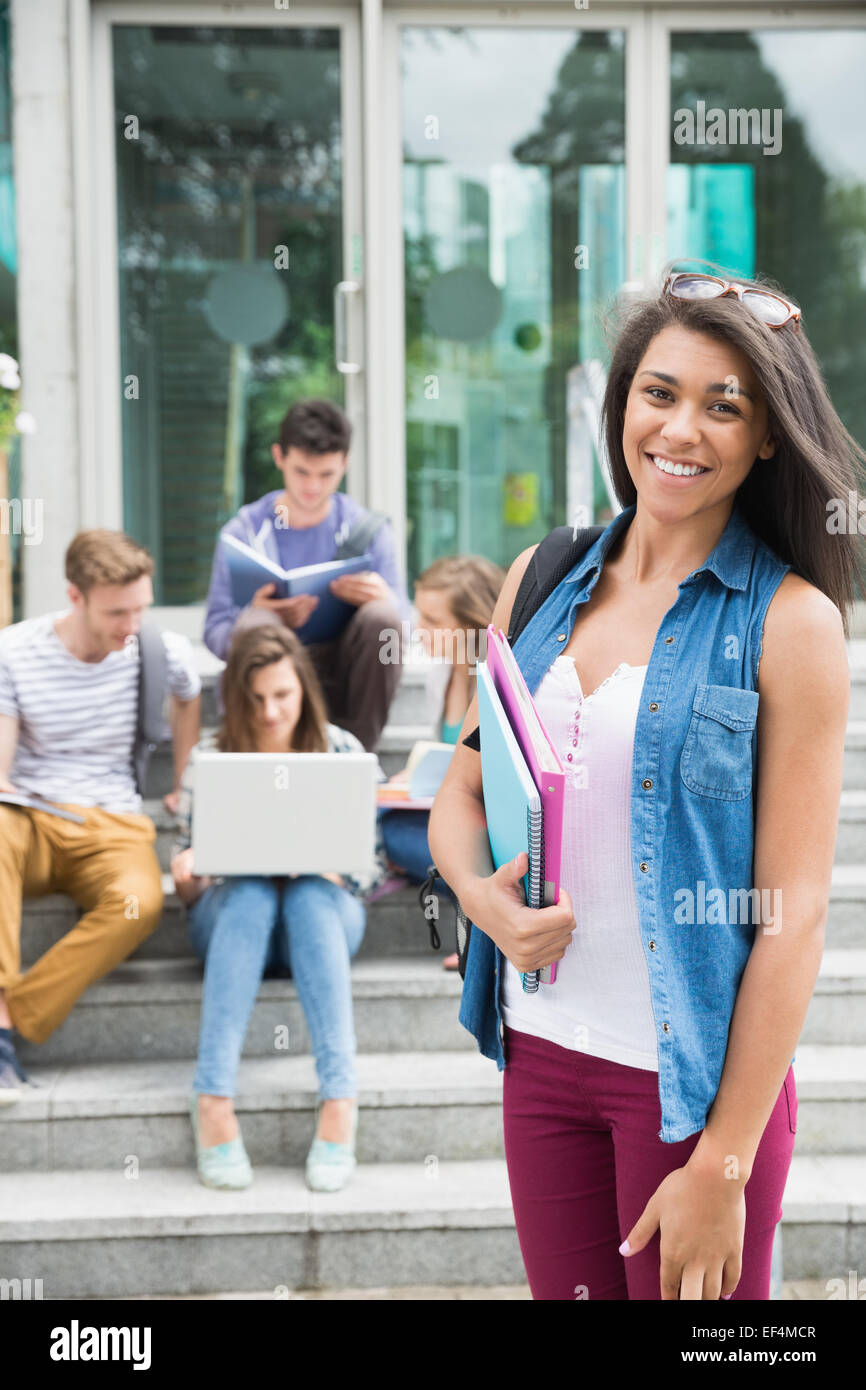 Pretty student smiling at camera outside Stock Photo - Alamy