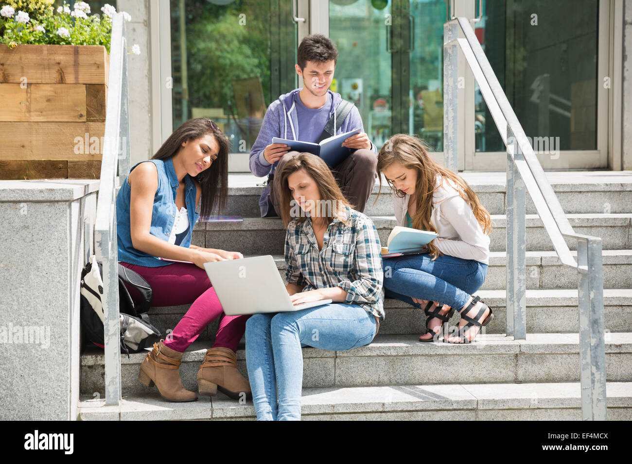 Students sitting on steps studying Stock Photo - Alamy