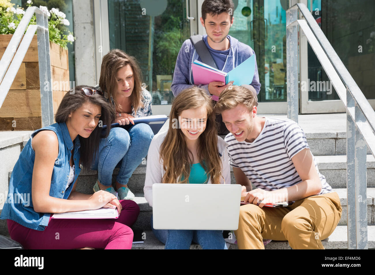 Students sitting on steps studying Stock Photo - Alamy