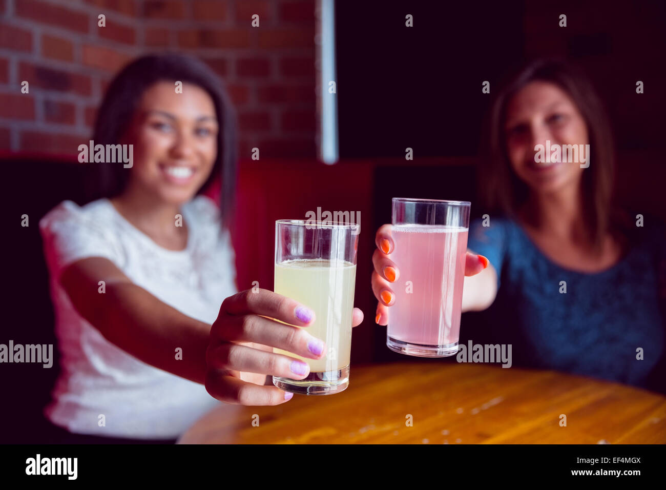 Happy friends toasting to camera Stock Photo - Alamy