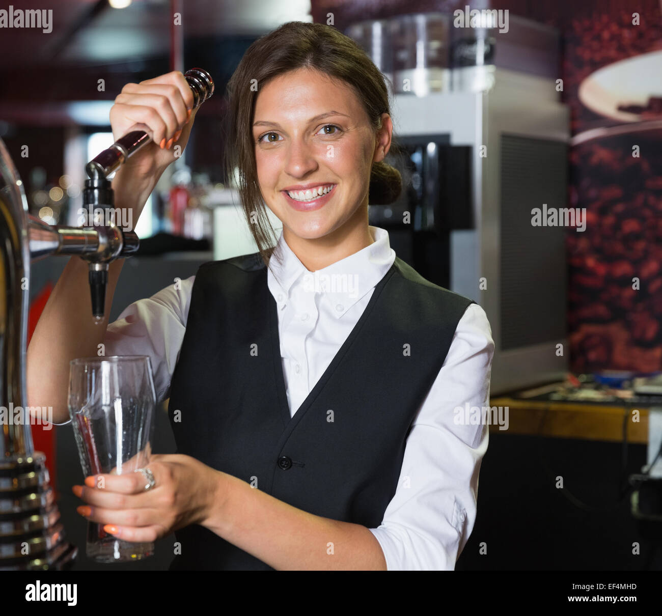 Happy barmaid pulling a pint of beer Stock Photo - Alamy