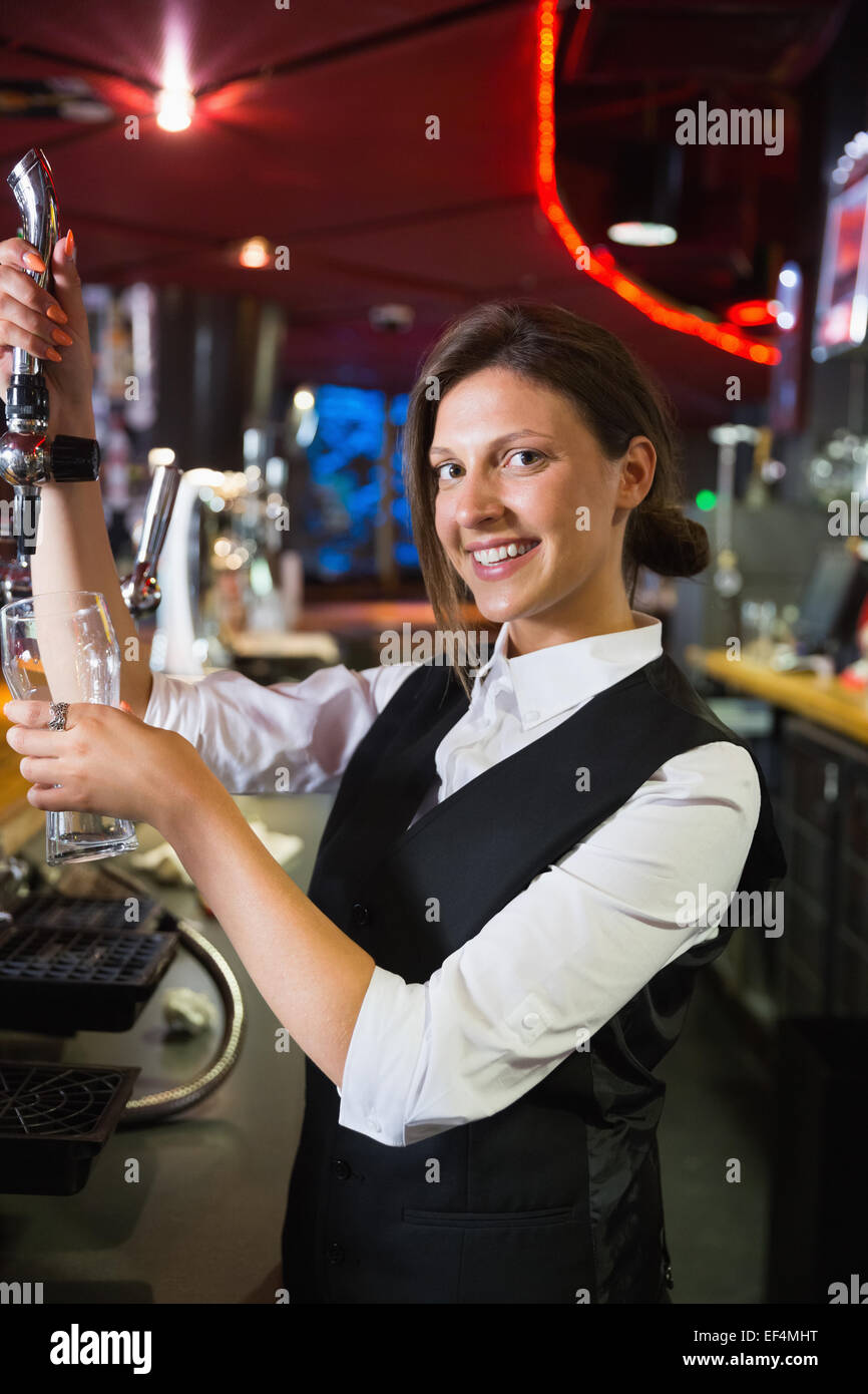 Happy barmaid pulling a pint of beer Stock Photo - Alamy
