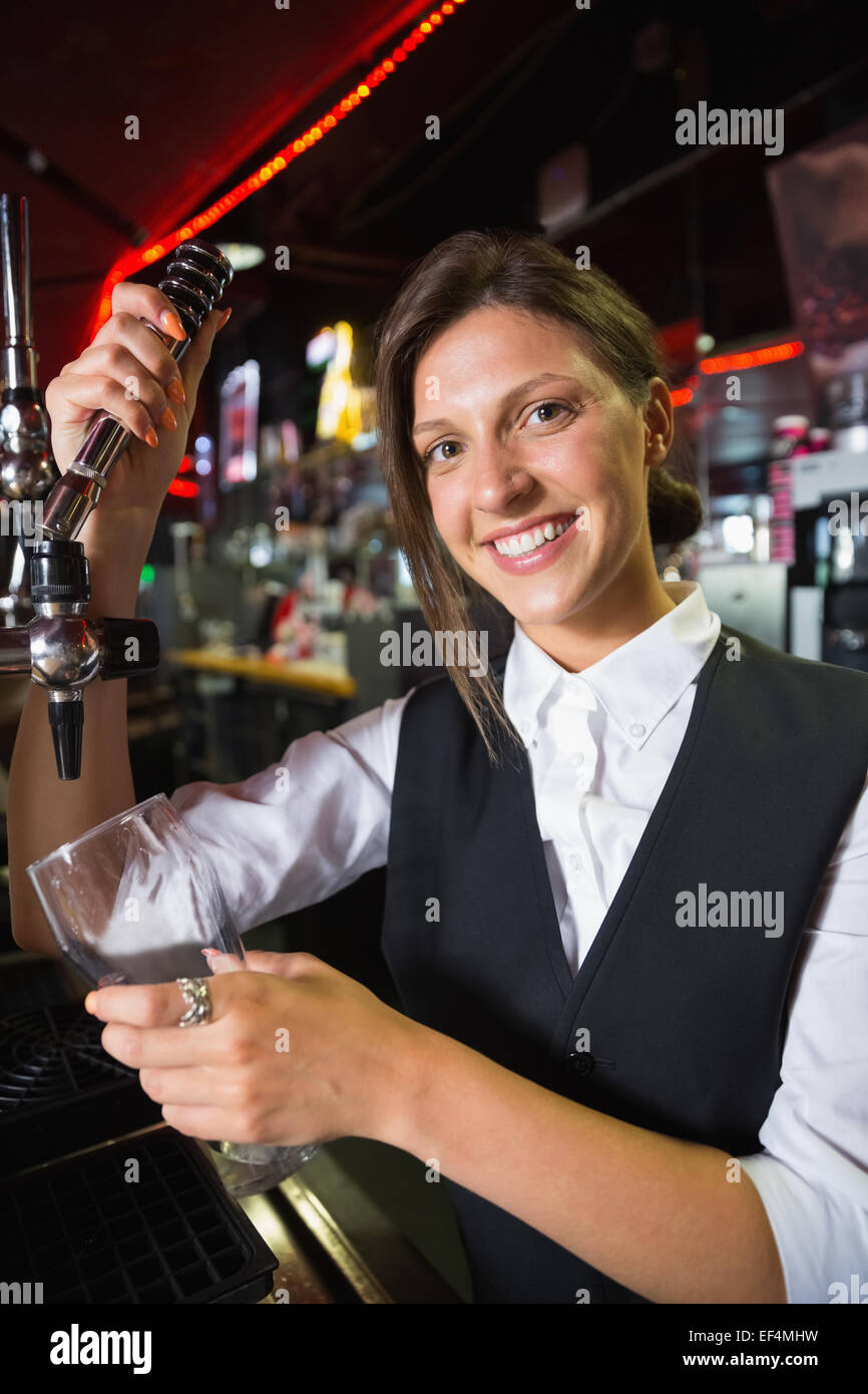 Happy barmaid pulling a pint of beer Stock Photo - Alamy