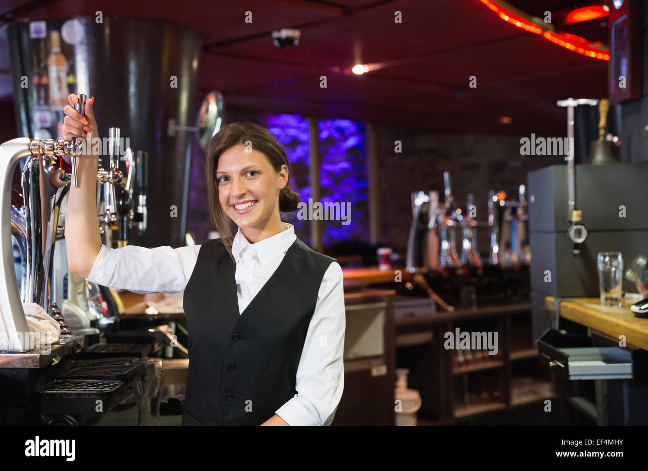 Happy barmaid pulling a pint of beer Stock Photo - Alamy