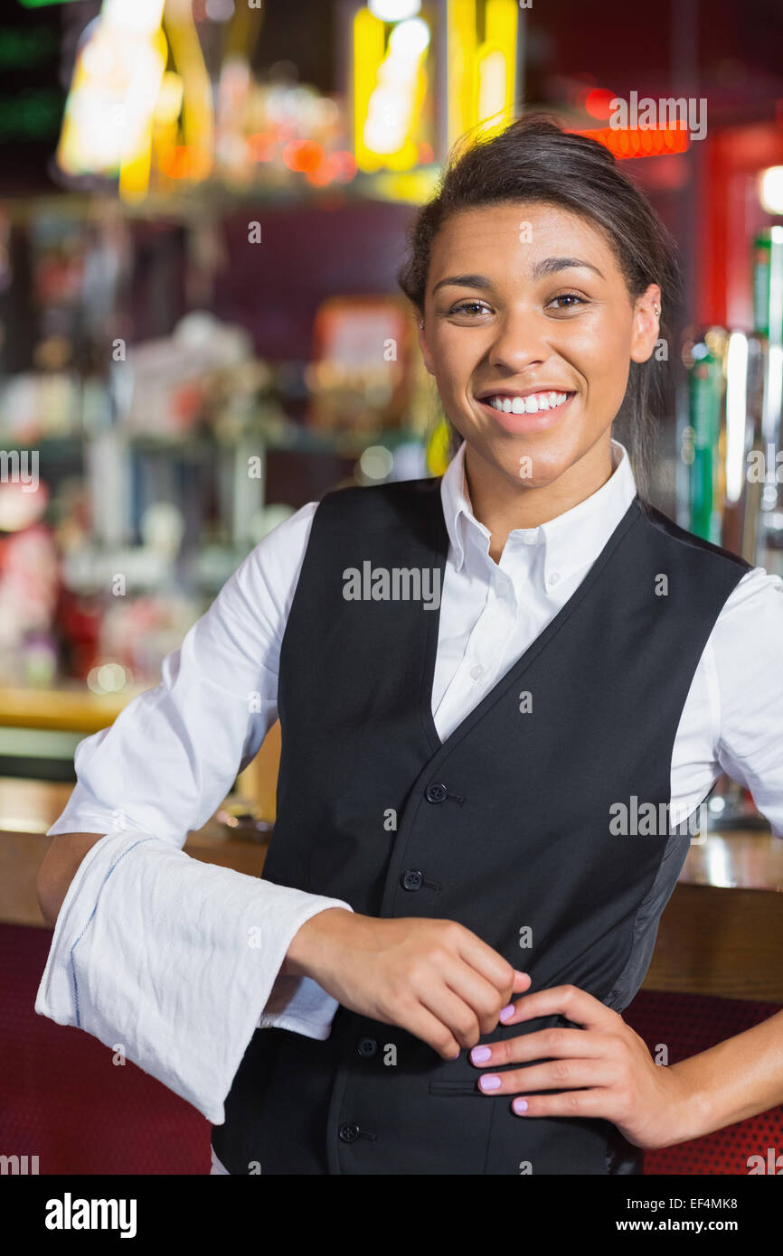 Pretty barmaid smiling at camera Stock Photo - Alamy