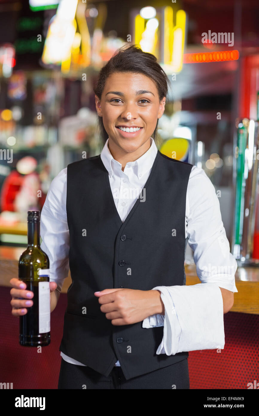 Pretty barmaid smiling at camera Stock Photo - Alamy