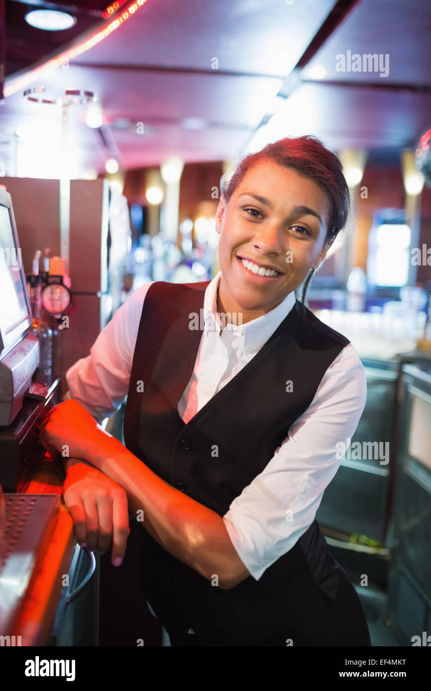 Pretty barmaid smiling at camera Stock Photo - Alamy