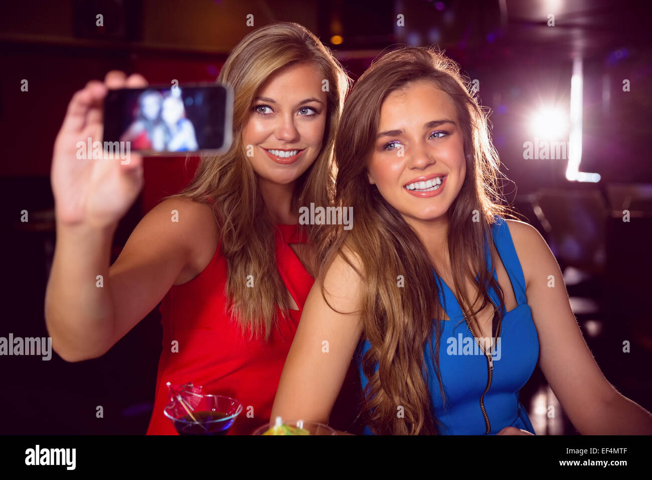 Pretty friends taking a selfie Stock Photo - Alamy