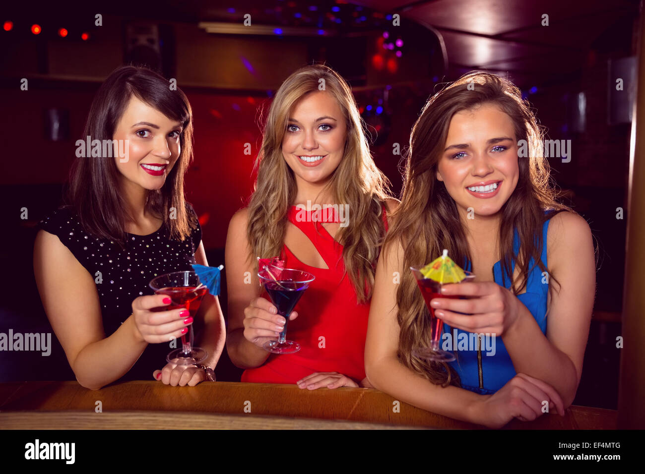 Pretty friends drinking cocktails together Stock Photo - Alamy