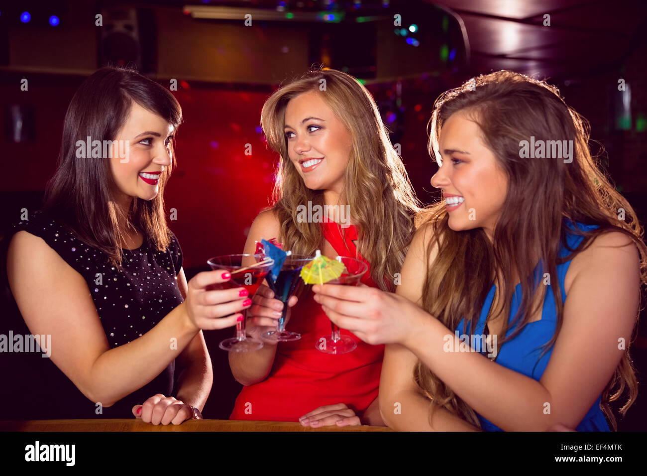 Pretty friends drinking cocktails together Stock Photo - Alamy
