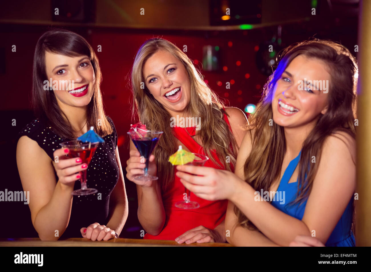 Pretty friends drinking cocktails together Stock Photo - Alamy