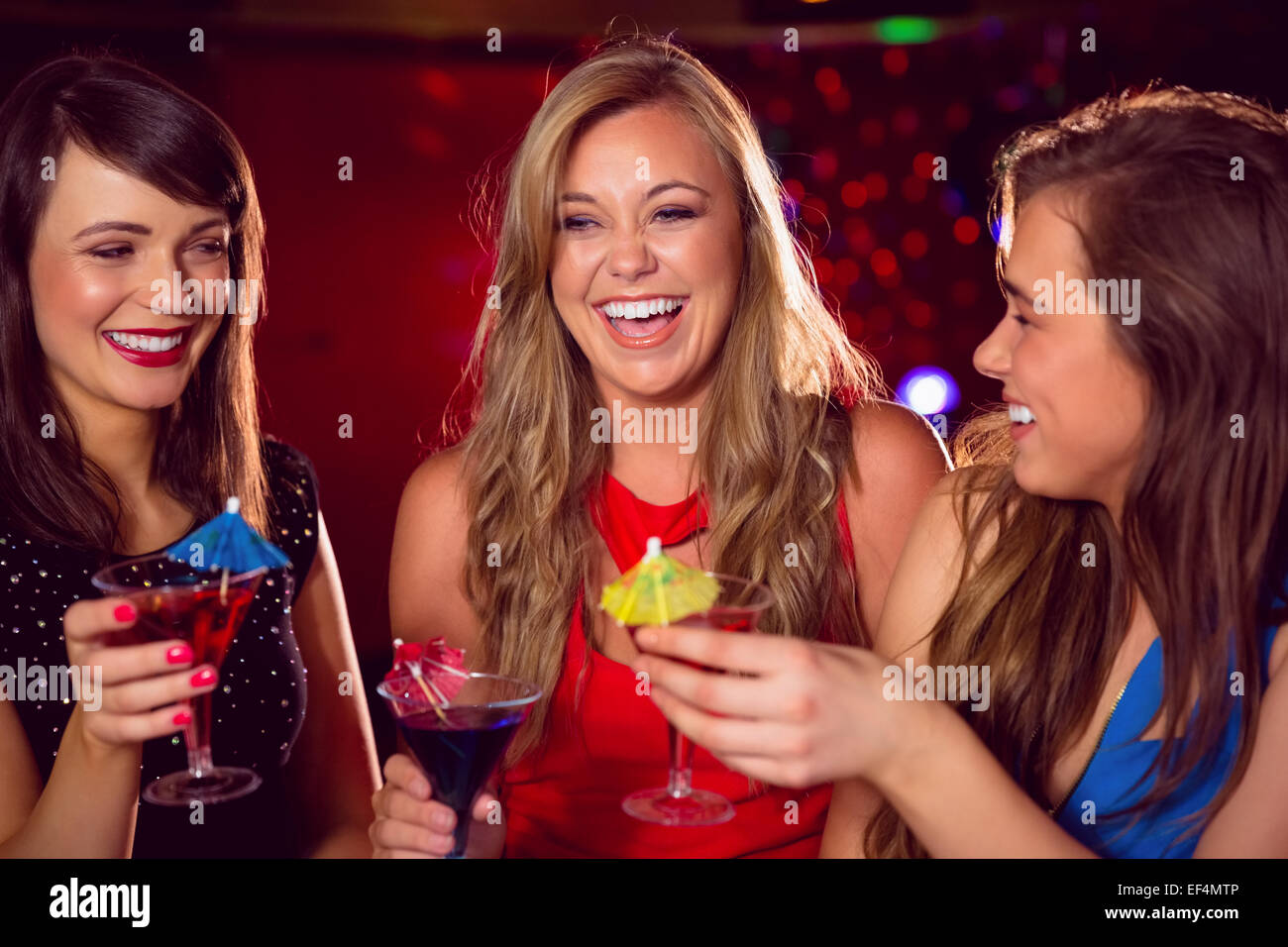 Pretty friends drinking cocktails together Stock Photo - Alamy