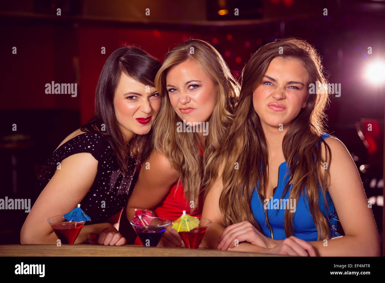 Pretty friends drinking cocktails together Stock Photo - Alamy