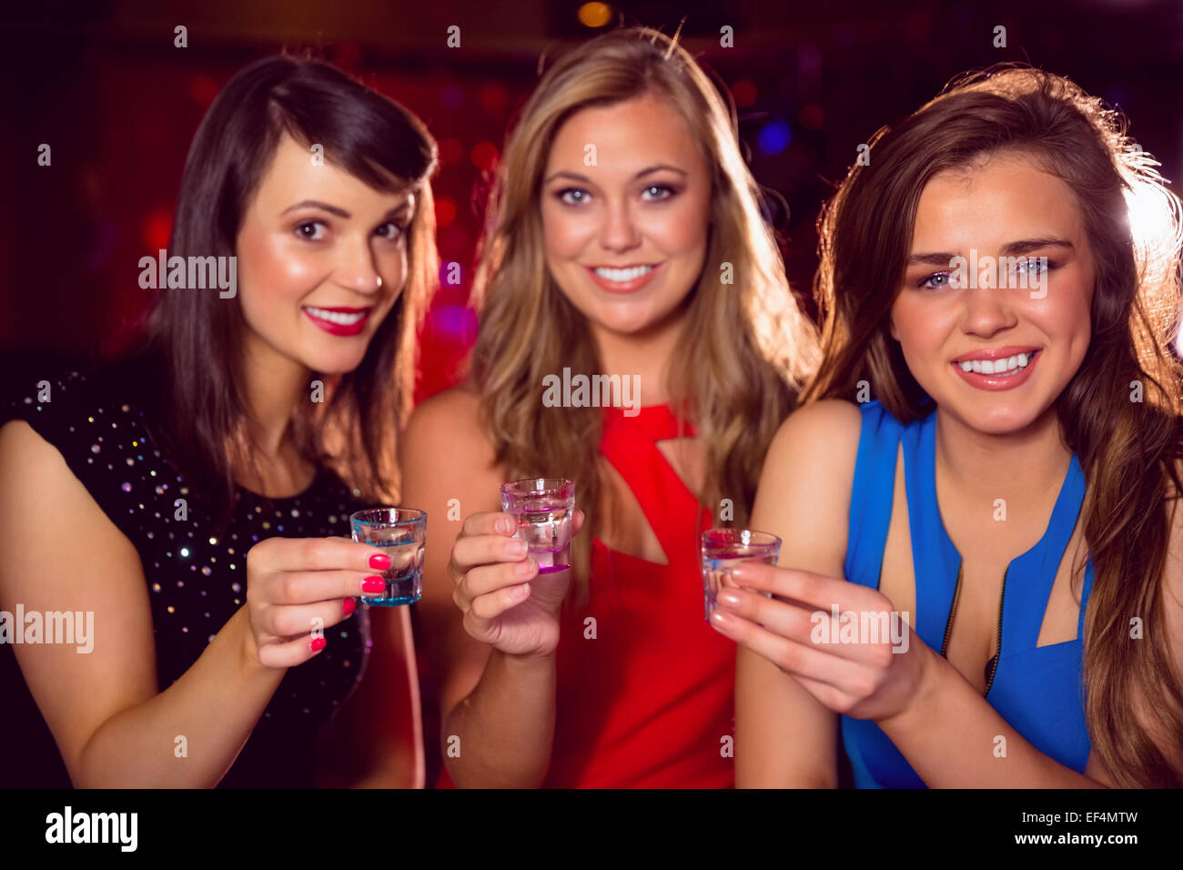 Pretty friends drinking shots together Stock Photo - Alamy