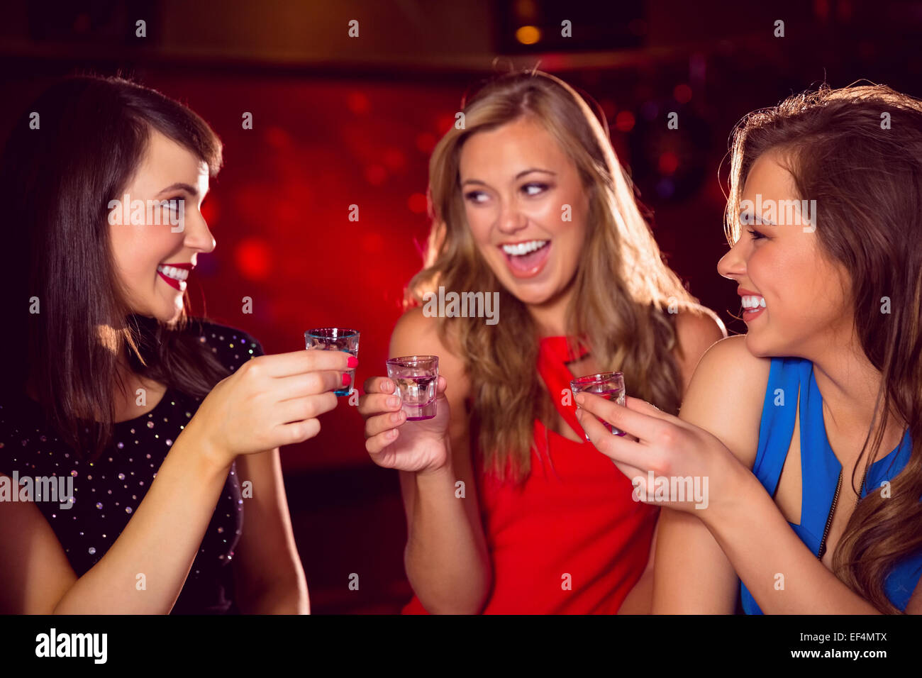 Pretty friends drinking shots together Stock Photo - Alamy
