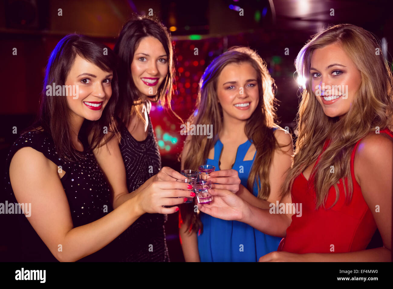 Pretty friends drinking shots together Stock Photo - Alamy