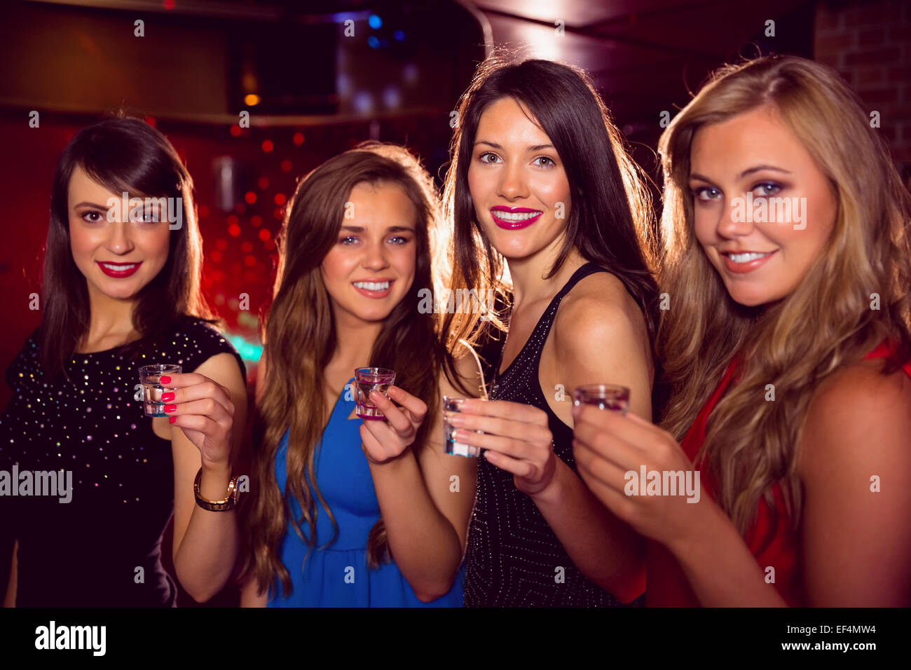Pretty friends drinking shots together Stock Photo - Alamy
