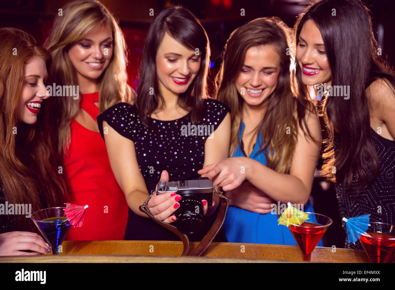 Pretty friends looking at camera together Stock Photo - Alamy
