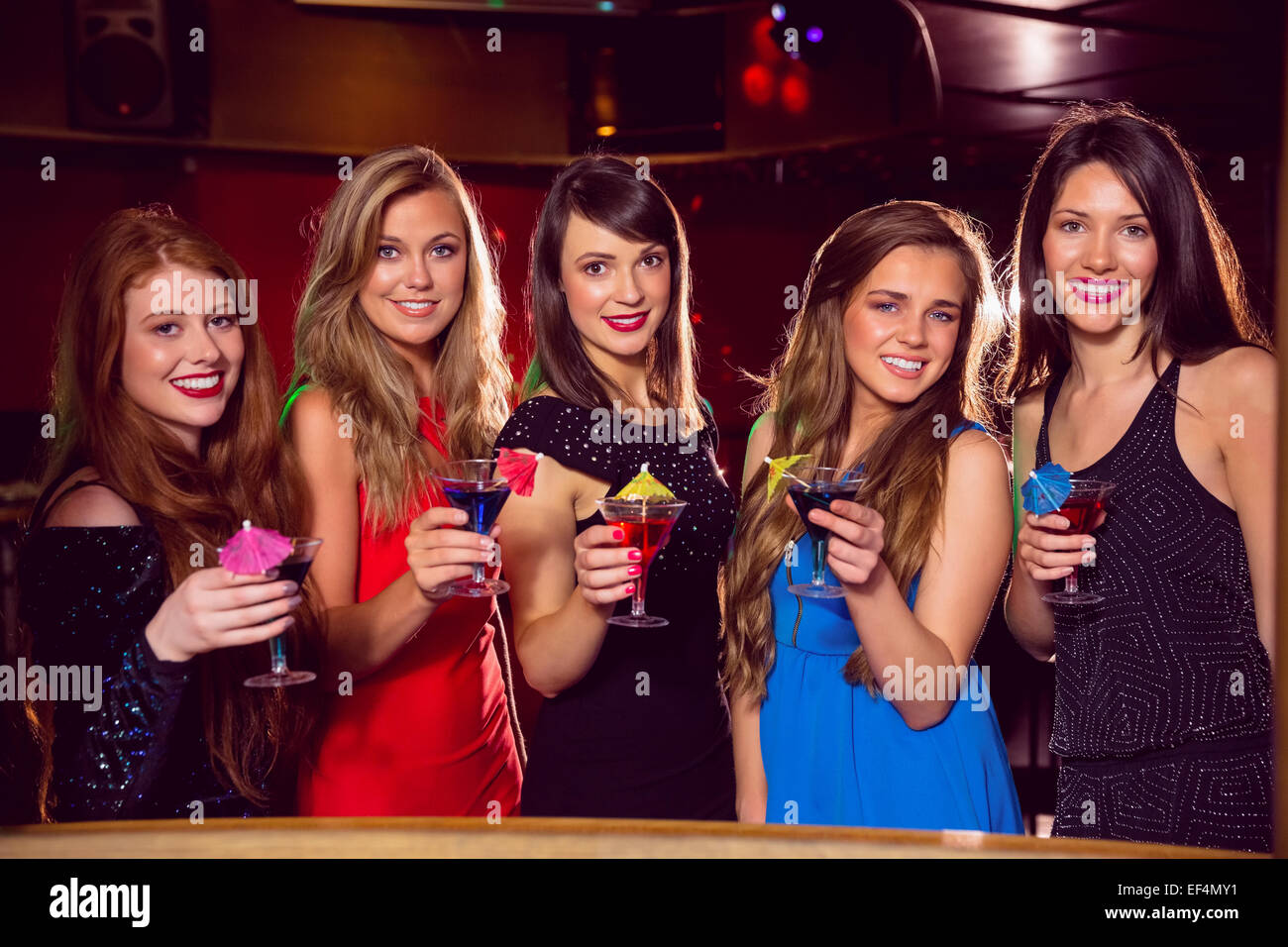 Pretty friends drinking cocktails together Stock Photo - Alamy