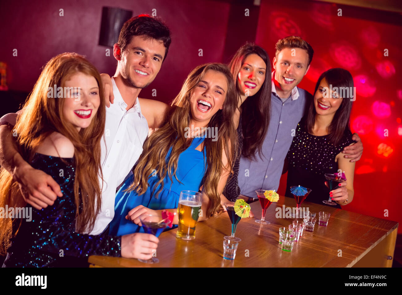 Happy friends on a night out together Stock Photo - Alamy
